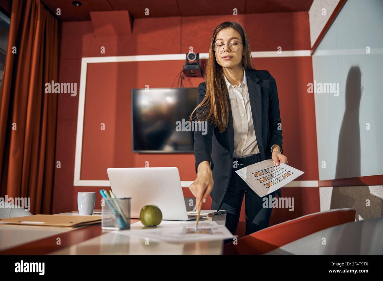 Focused draftswoman looking at the floor plan Stock Photo - Alamy