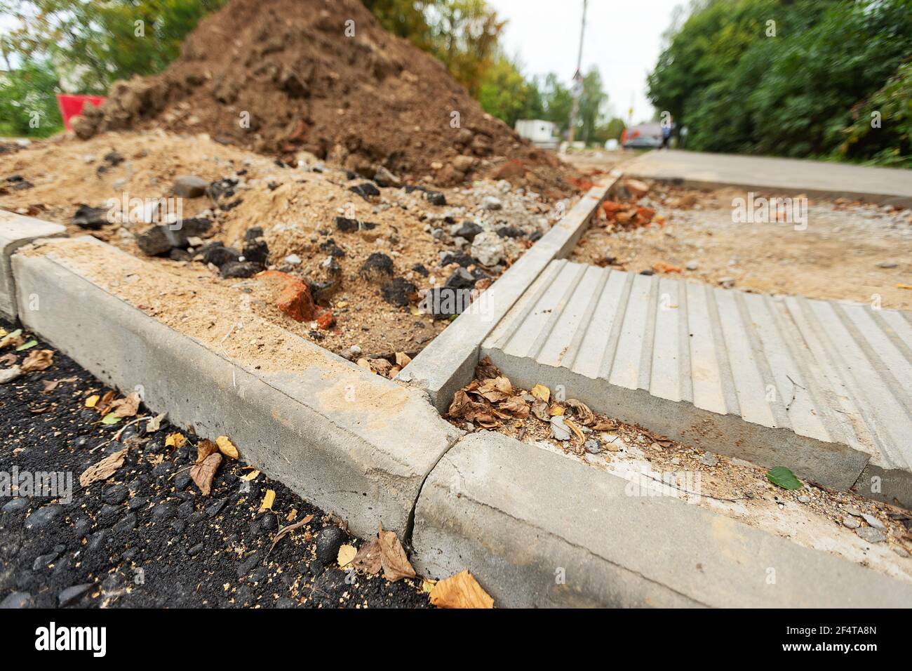 poorly executed road repairs. replacing the old curb stone with a new ...