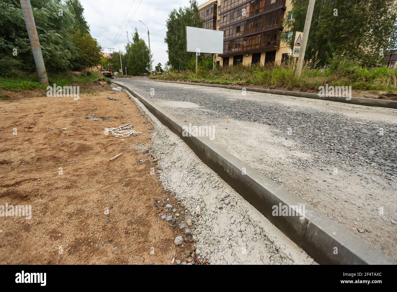 poorly executed road repairs. replacing the old curb stone with a new ...