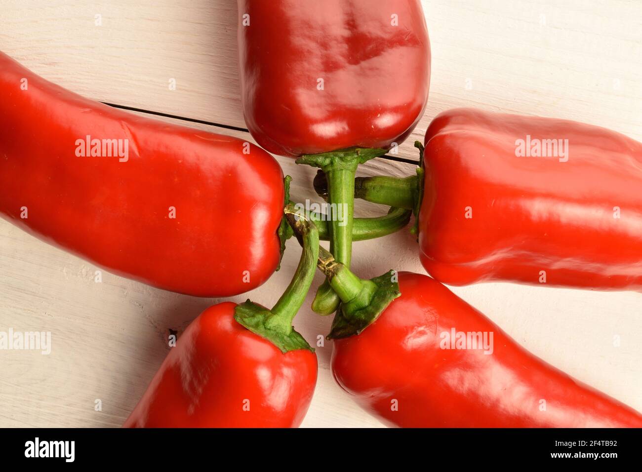 A few ripe organic tasty sweet Kapia peppers on a natural wood ...