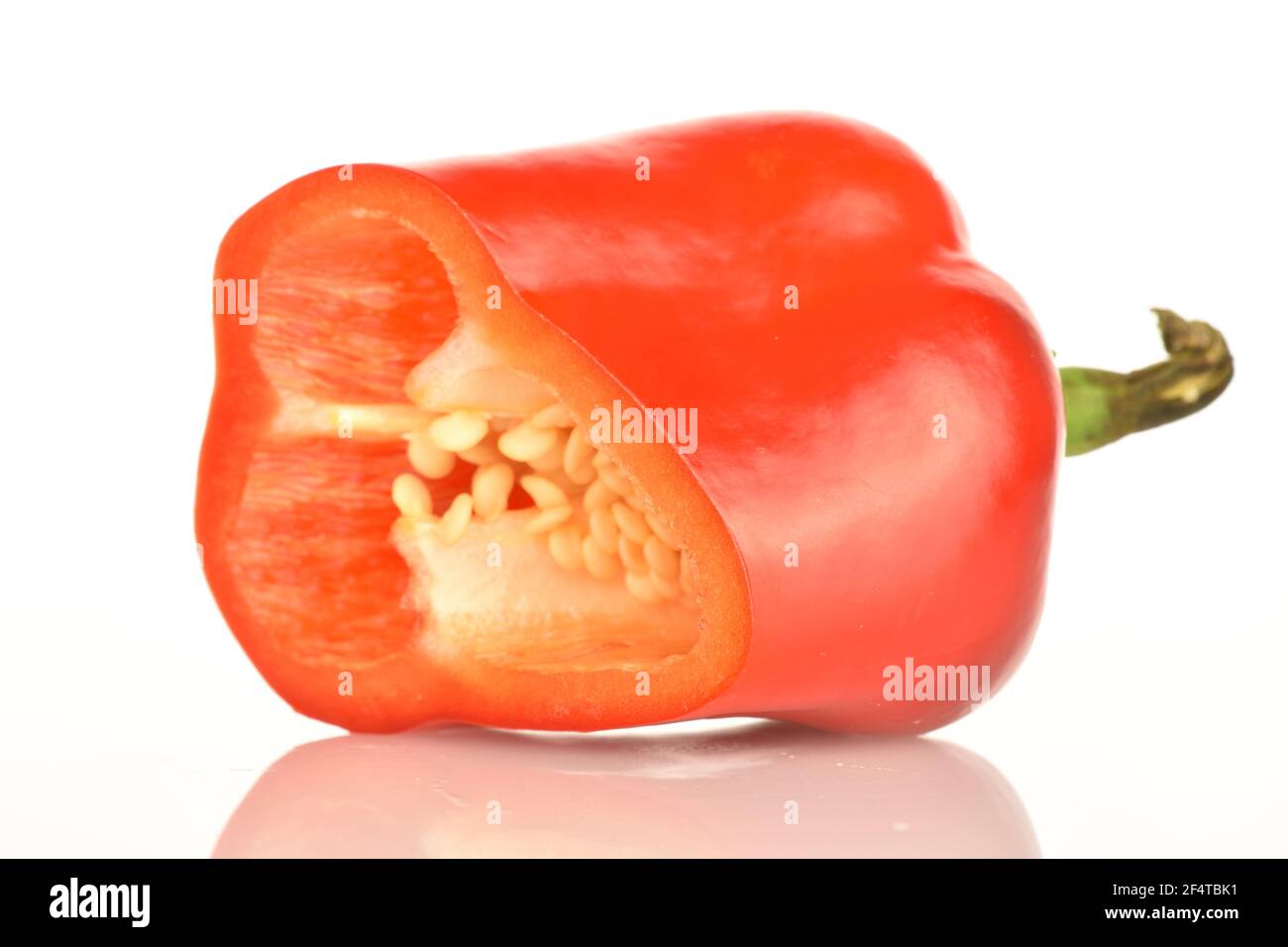 One half of fresh ripe tasty sweet red Kapia pepper on a white ...