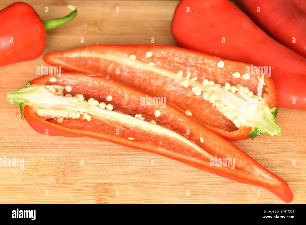 Three whole and two halves of fresh ripe tasty organic sweet red Kapia ...
