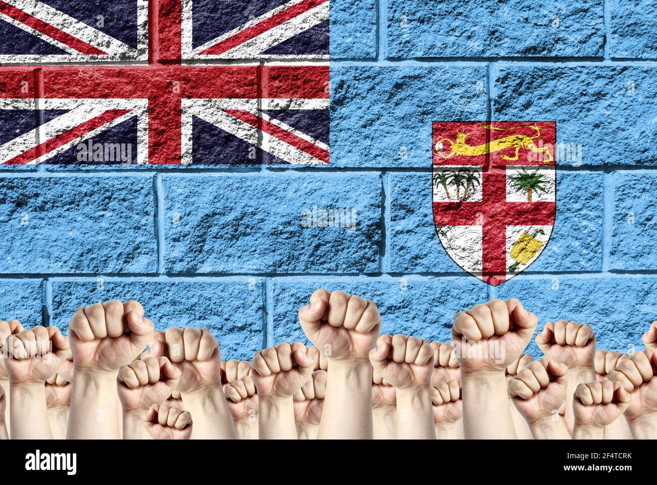 Raised fists against the background of the depicted flag of Fiji on a ...