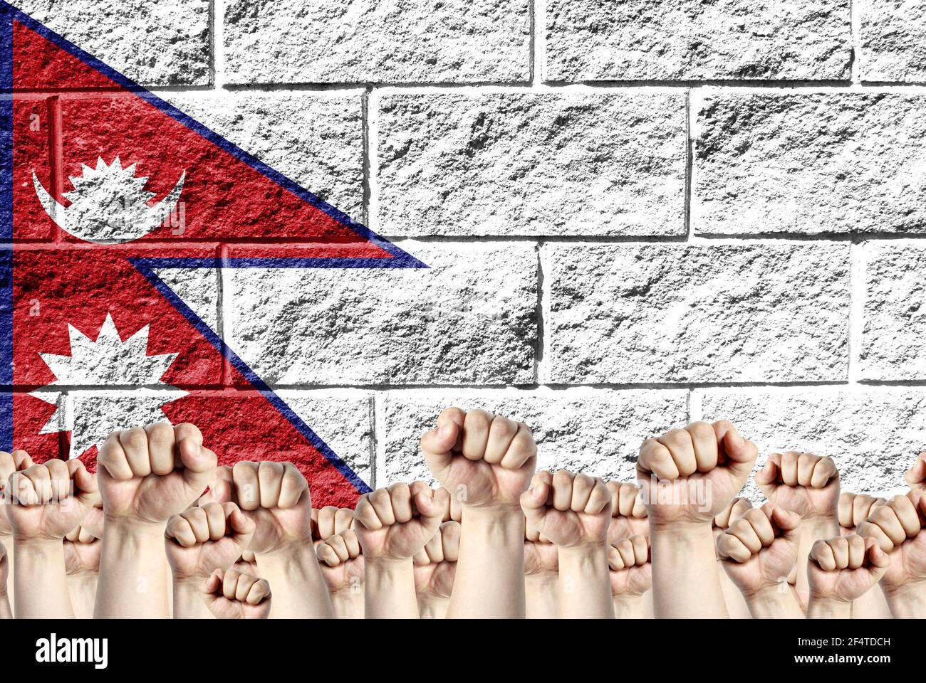 Raised fists against the background of the depicted flag of Nepal on a ...