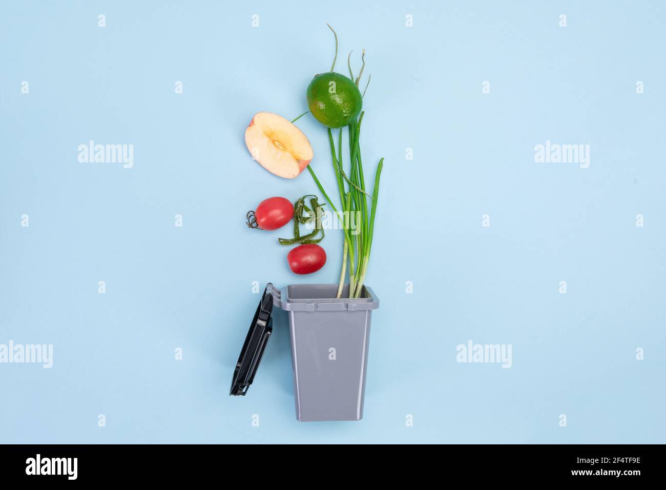 Organic waste and trash bin on blue background - the concept of ...