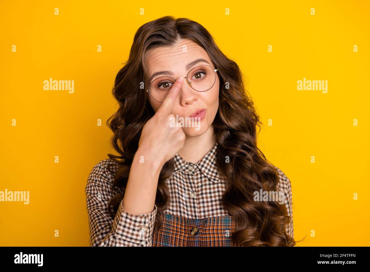 Portrait of attractive funny smart wavy-haired girl in checked uniform ...