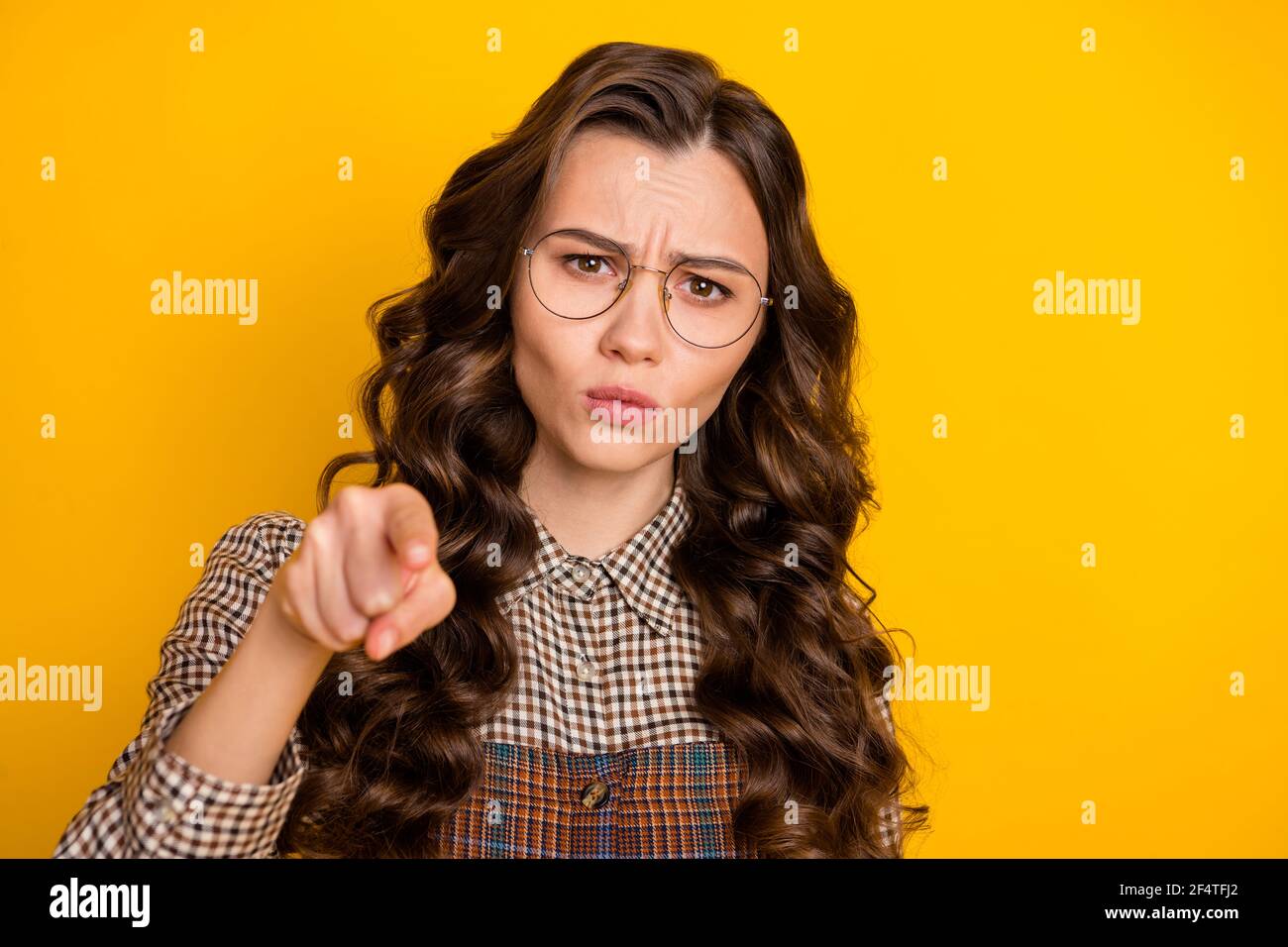Portrait of attractive gloomy sullen smart wavy-haired girl in checked ...