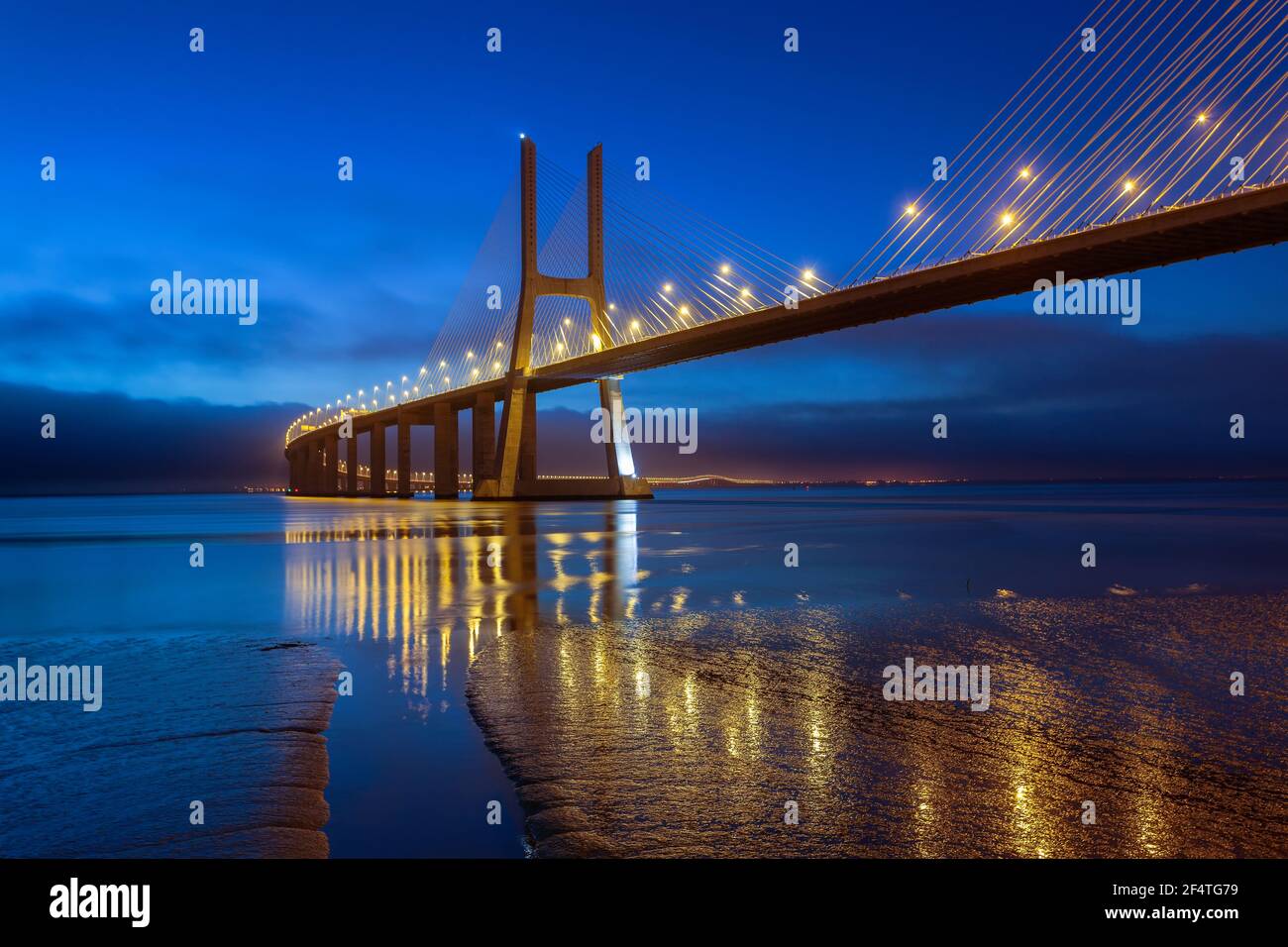 Night lights on the Lisbon bridge. The Vasco da Gama Bridge is a ...