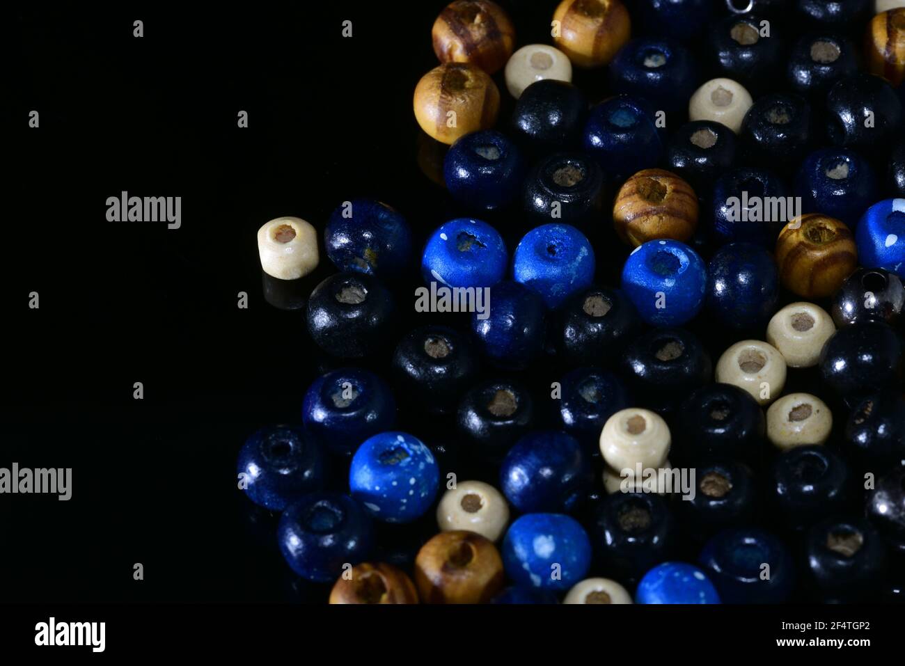 Coloured beads on black background hi-res stock photography and images ...