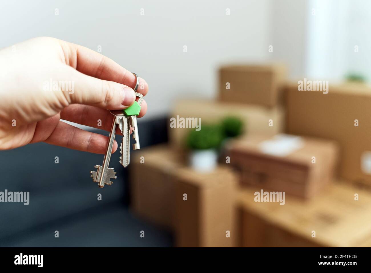 Hand with house key. Real estate and moving concept Stock Photo - Alamy
