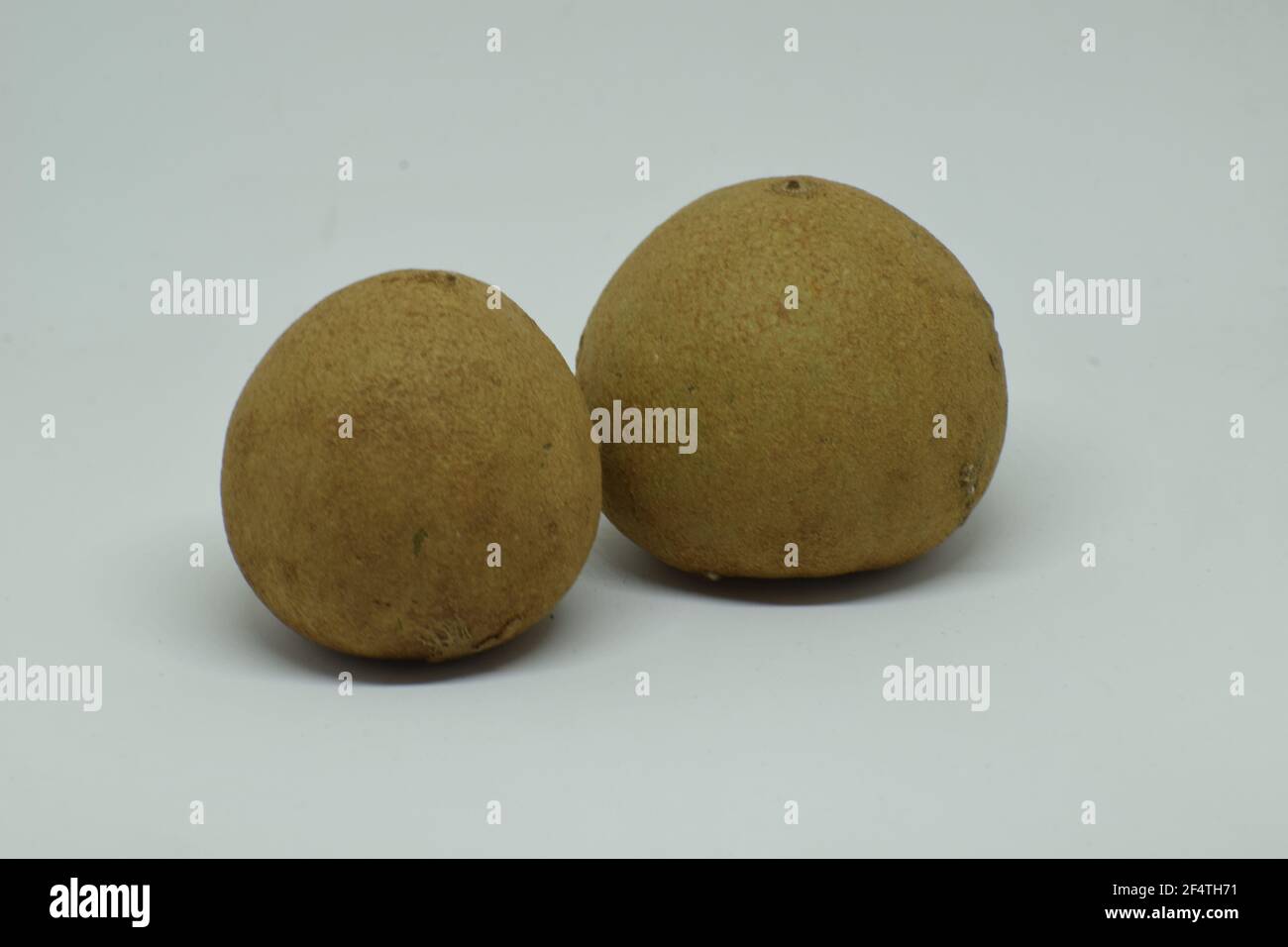 Two Sapodilla or Sapota fruits isolated on a white background Stock ...