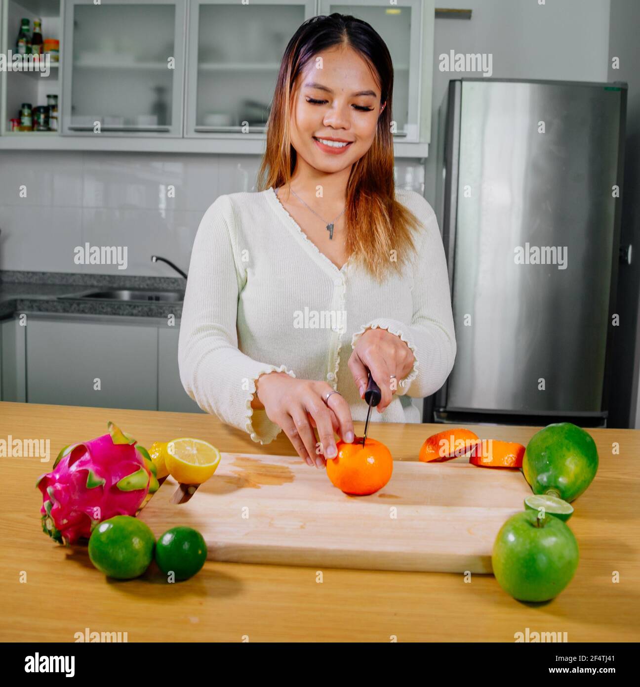 Asian girl cooking healthy vegetarian and vegan food, vegetables and ...