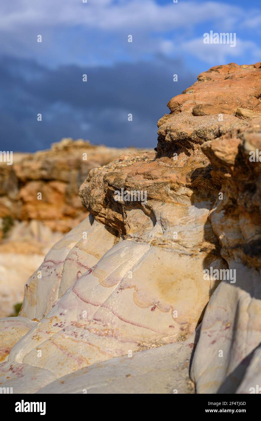 Rock near the sea with multiple colors in the cut and lines Stock Photo ...