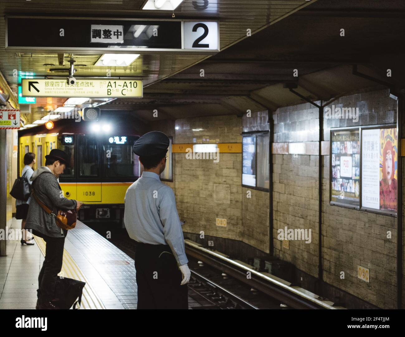 Tokyo, Japan - Subway train coming the station and the security officer ...