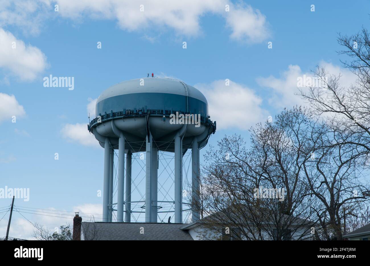 Generic water tower sits high above residential homes in suburban ...