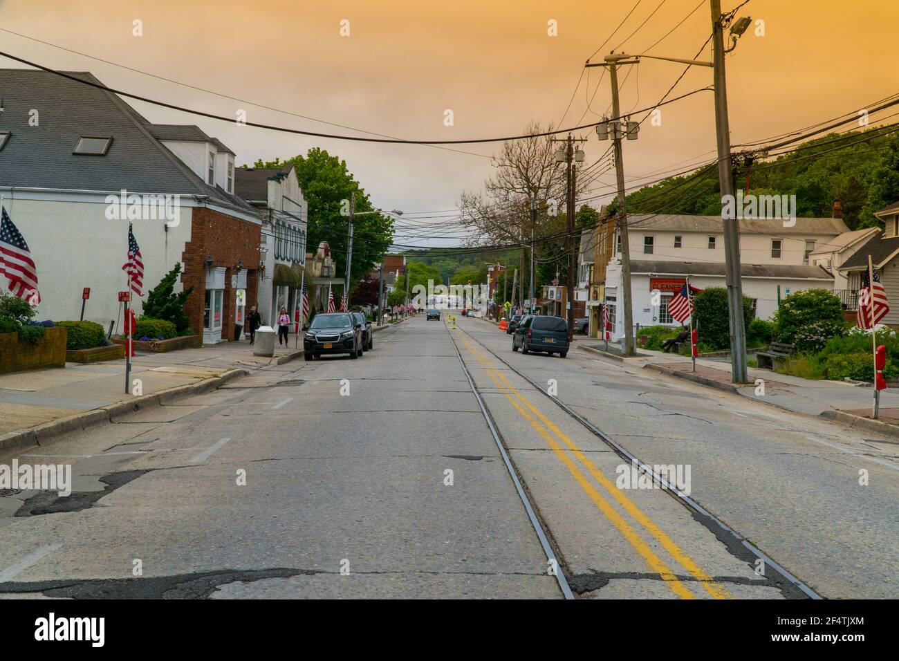 Exterior view down generic main street in small town USA as sunrise ...
