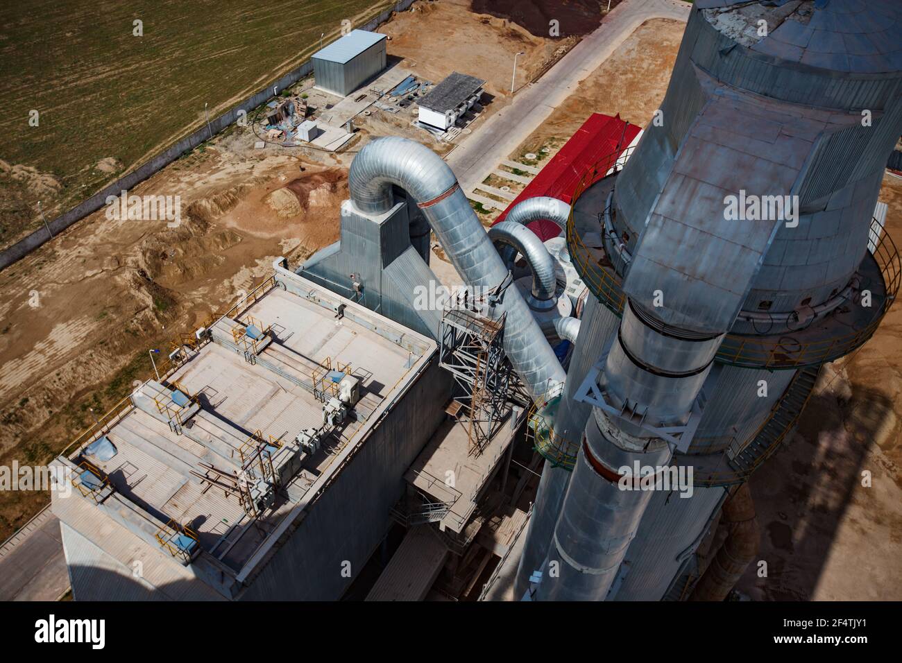 Standard Cement plant. View from top on part of plant. Tower, tubes and ...