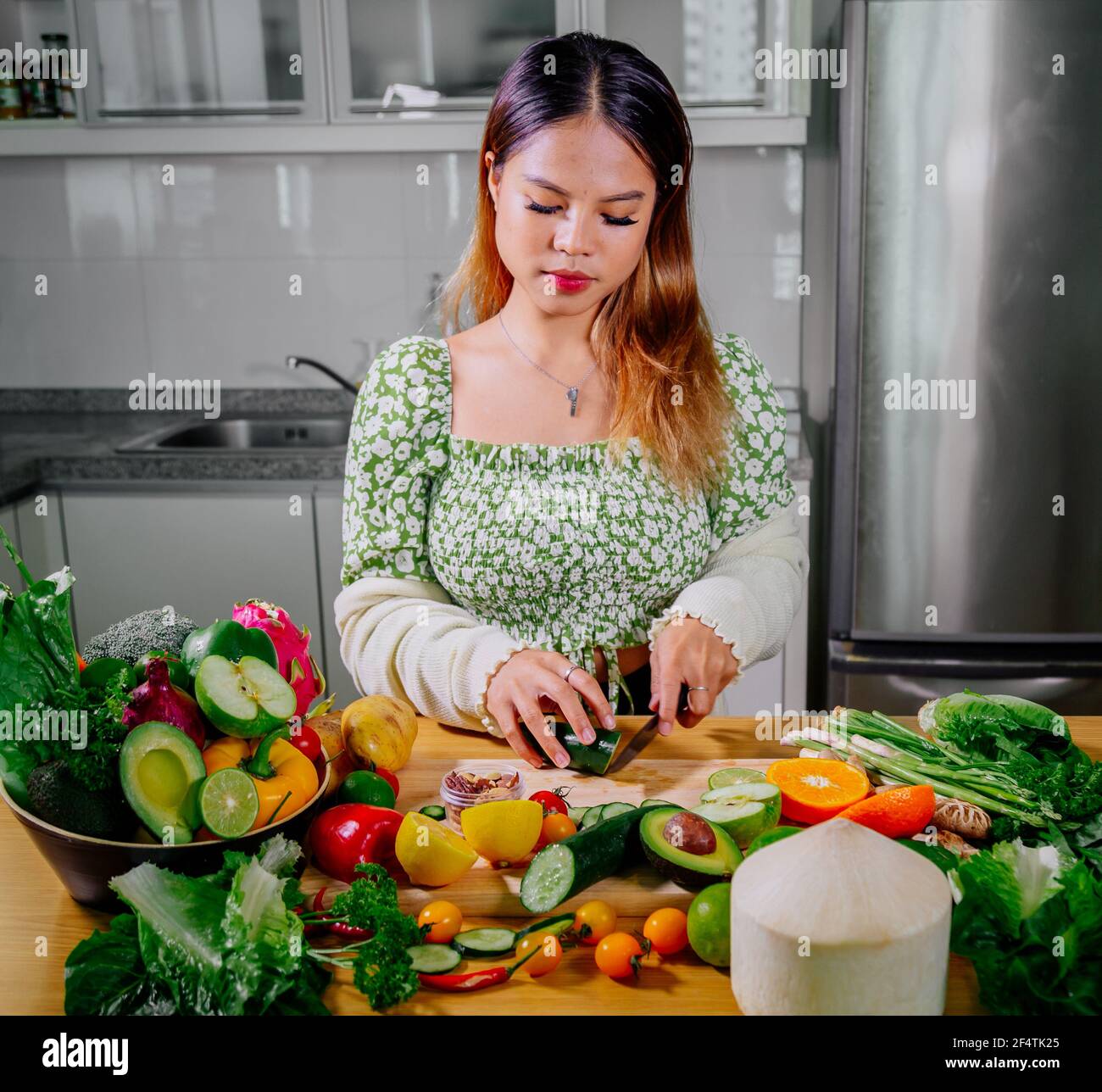 Asian girl cooking healthy vegetarian and vegan food, vegetables and ...