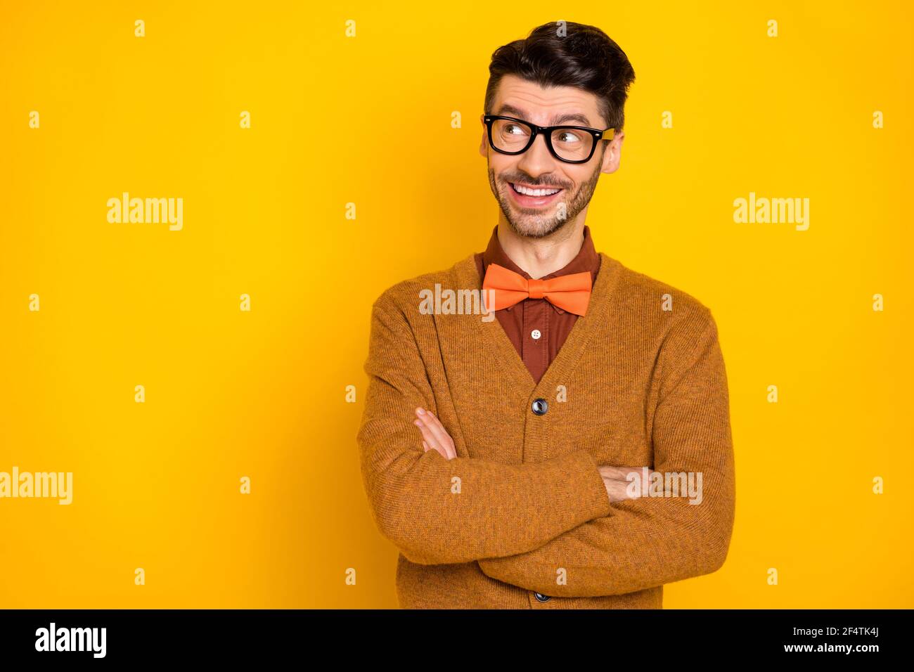 Portrait of attractive cheerful curious guy folded arms creating ...