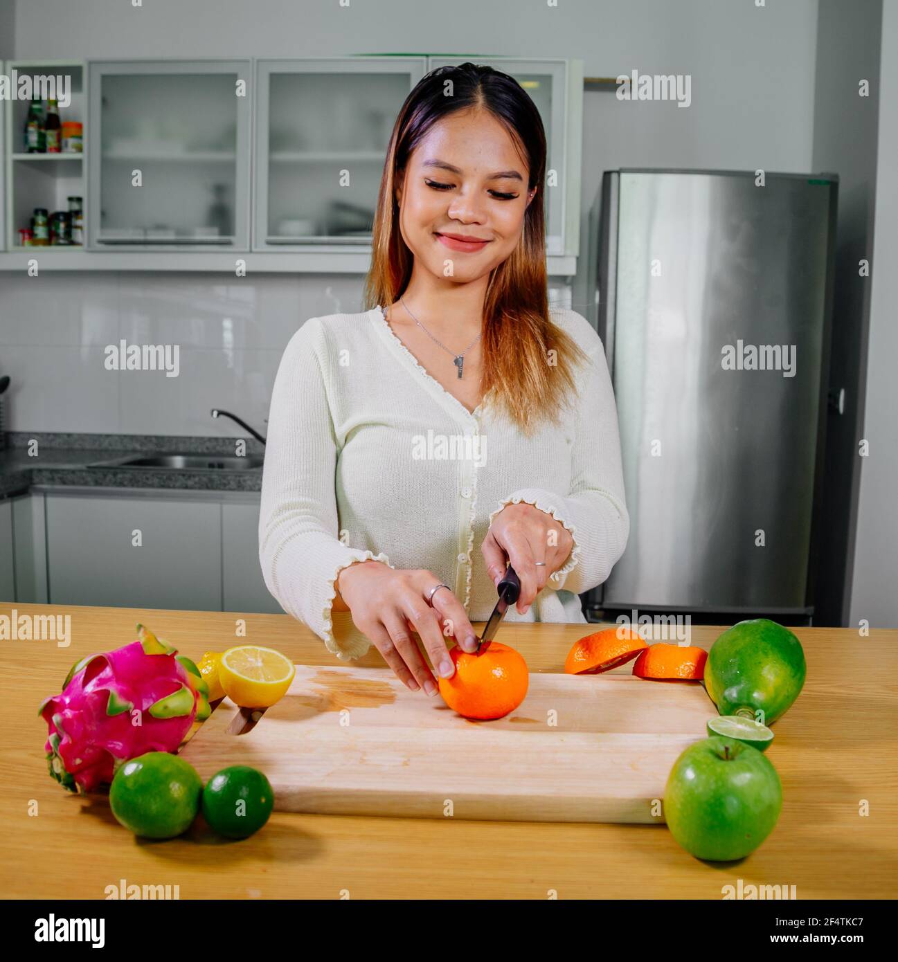 Asian girl cooking healthy vegetarian and vegan food, vegetables and ...