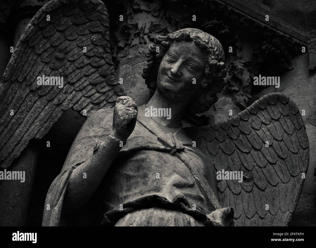 Smiling angel on facade of Notre Dame Cathedral in Reims, France. Black ...