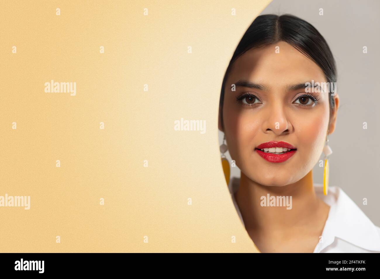 Woman looking from behind a wall hi-res stock photography and images ...