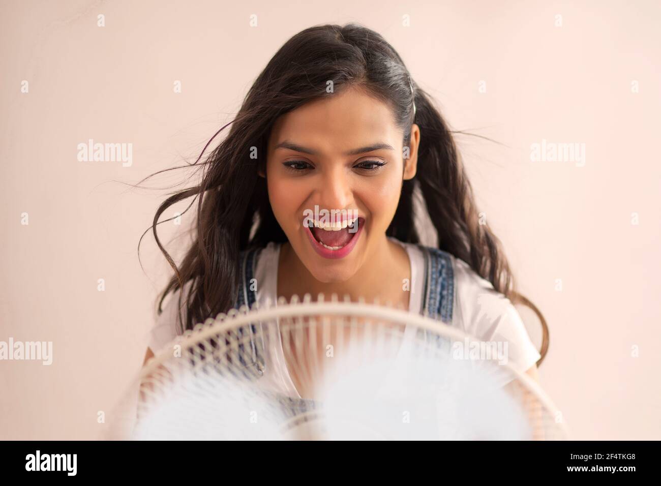 Person in front of fan hi-res stock photography and images - Alamy