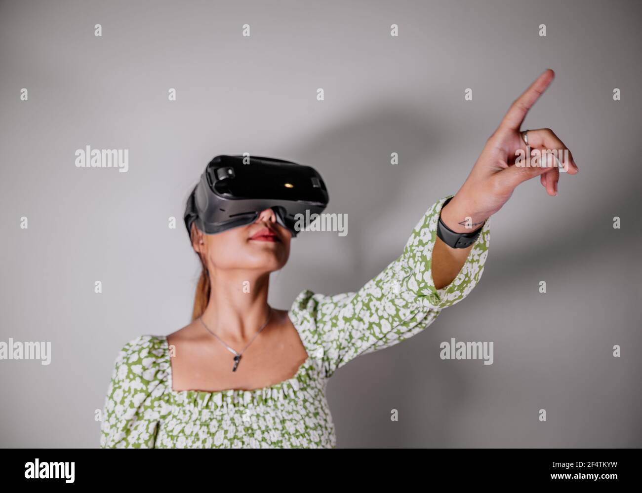 Asian Woman looking through virtual reality device at home. Augmented ...