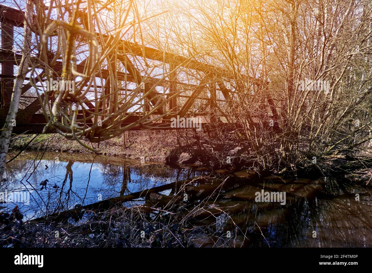 Old rusty railroad bridge over the river Ise near Gifhorn, Germany, is ...