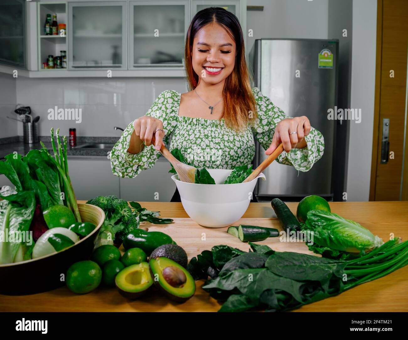 Asian girl cooking healthy vegetarian and vegan food, vegetables and ...