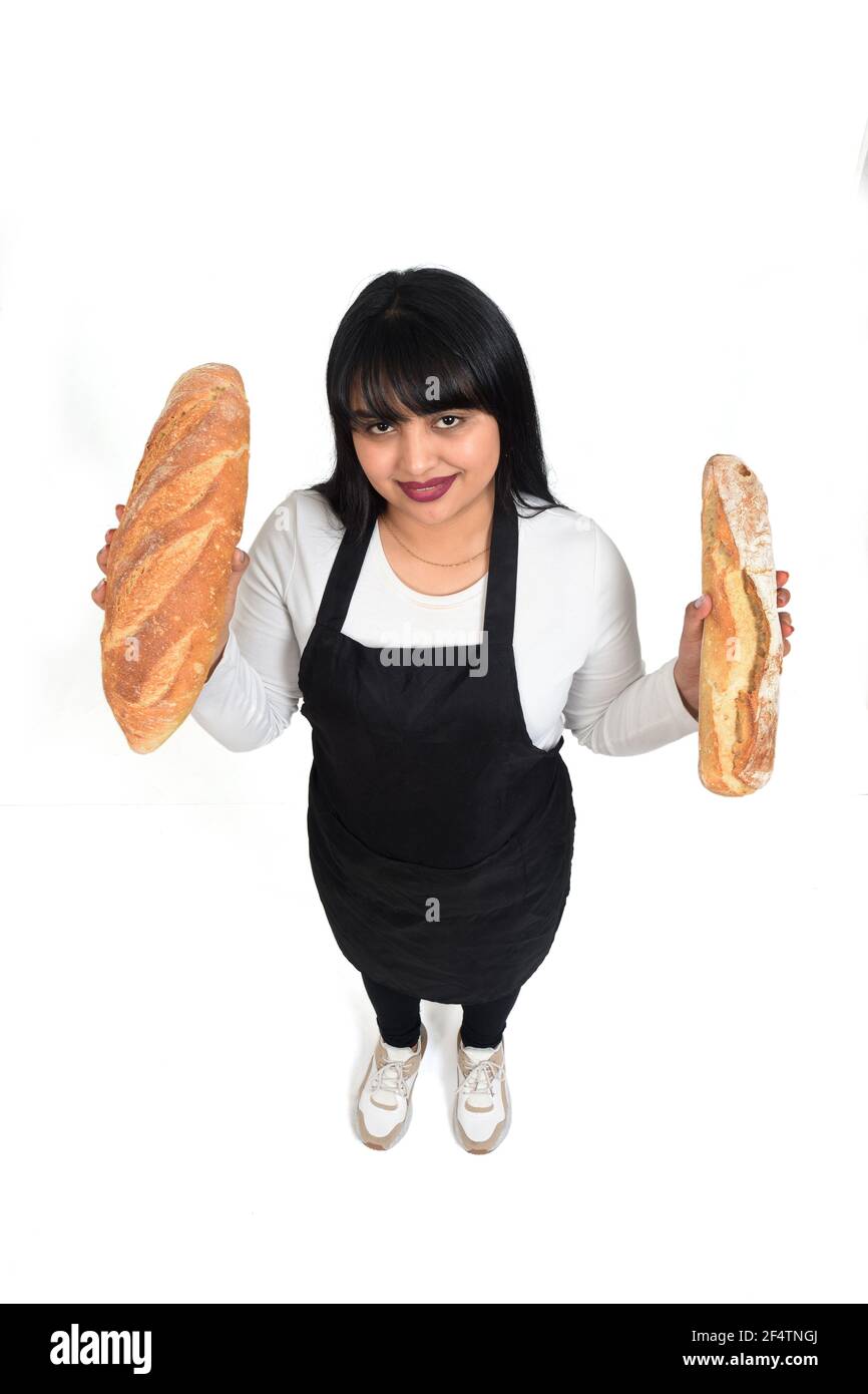 high angle view of portrait of a baker showing bread on white ...