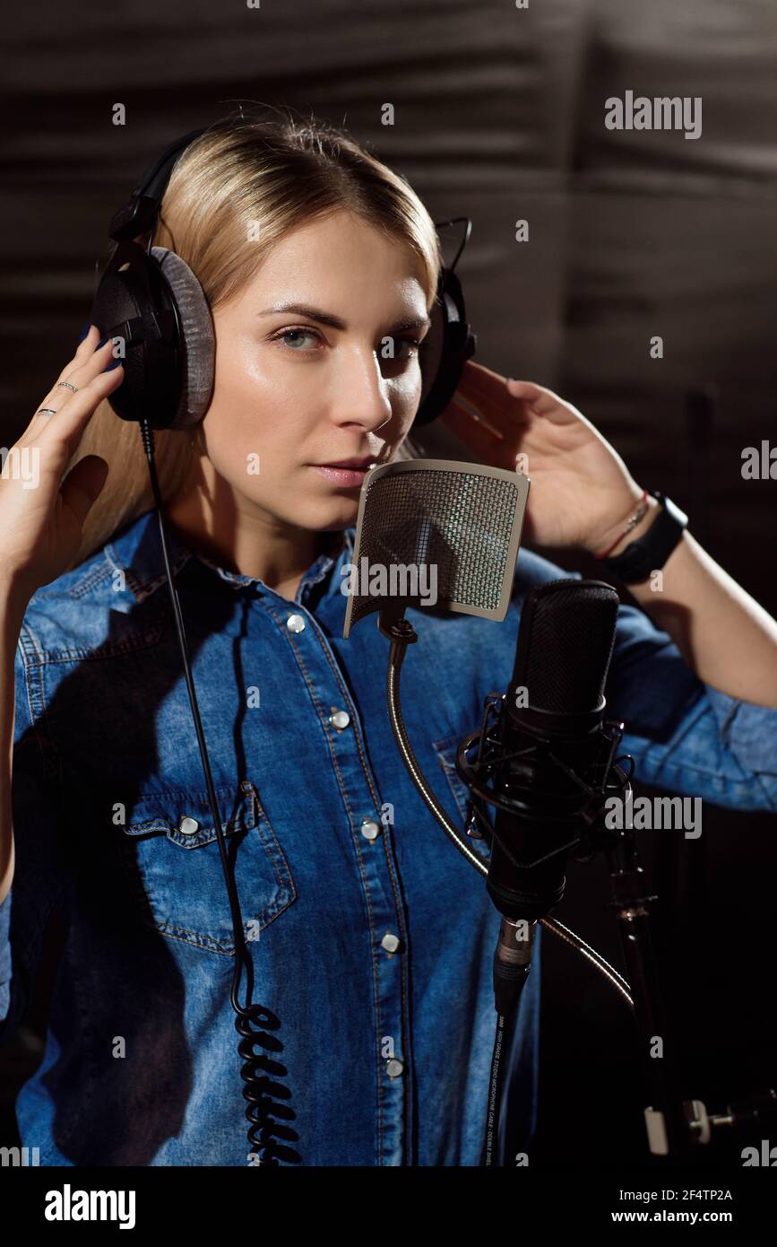 Young woman recording a song in the studio Stock Photo - Alamy
