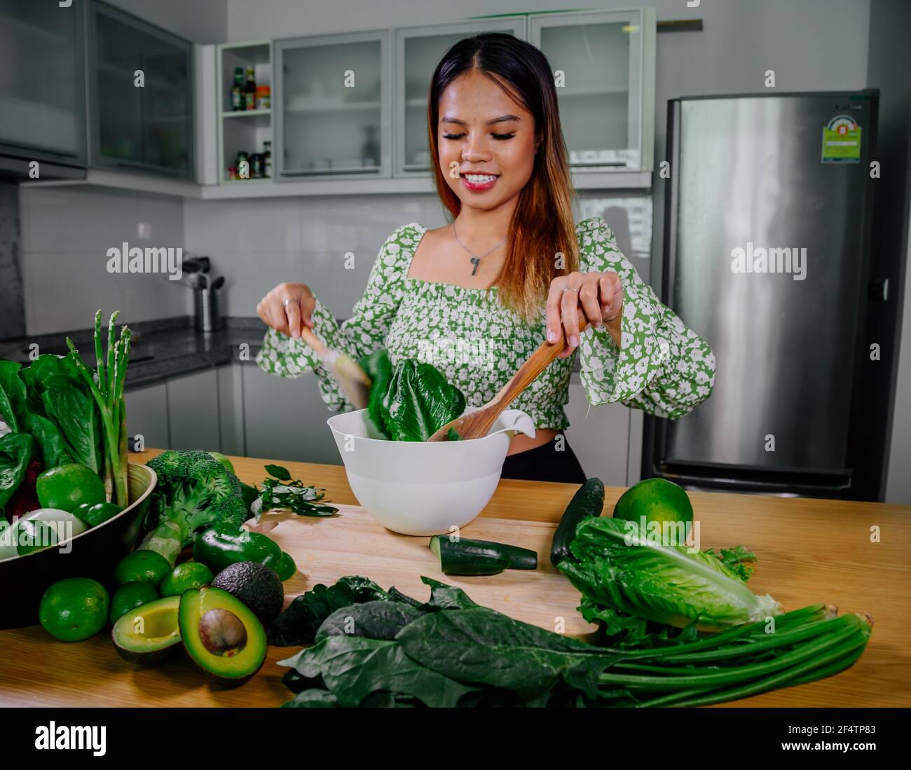Asian girl cooking healthy vegetarian and vegan food, vegetables and ...