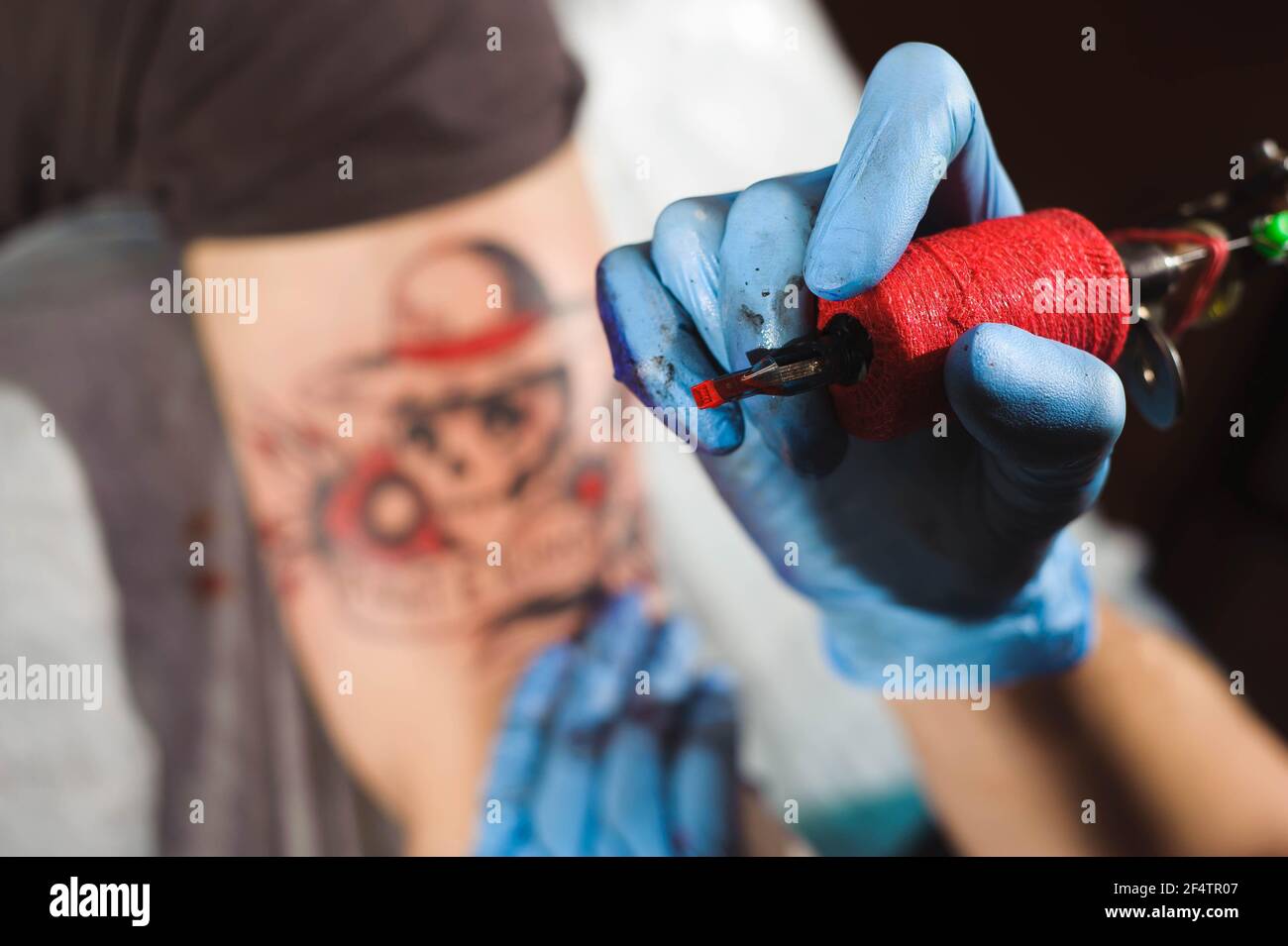 Process of making tattoo close-up, man creating picture on hand with it ...