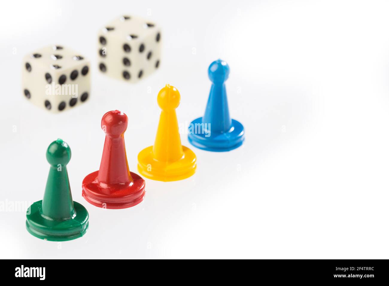 Colorful game pieces and dice Stock Photo - Alamy