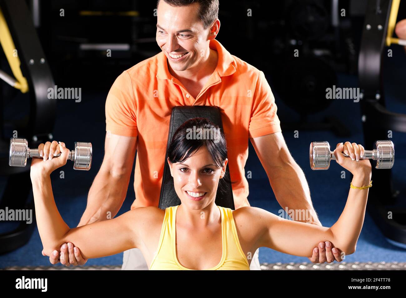 Woman does outdoor stretching with her personal trainer on a great ...