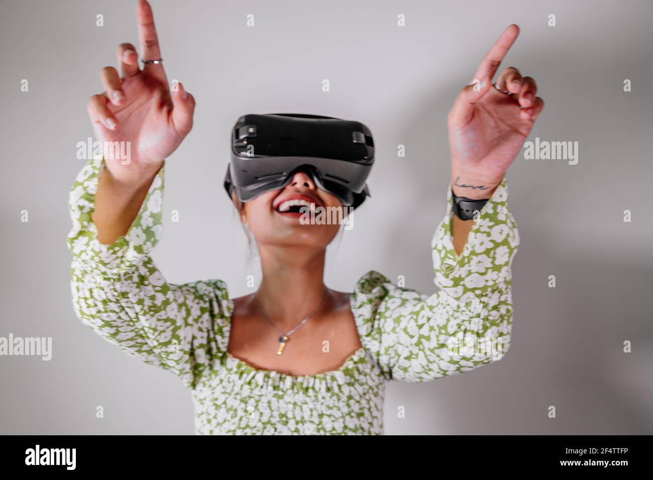Asian Woman looking through virtual reality device at home. Augmented ...