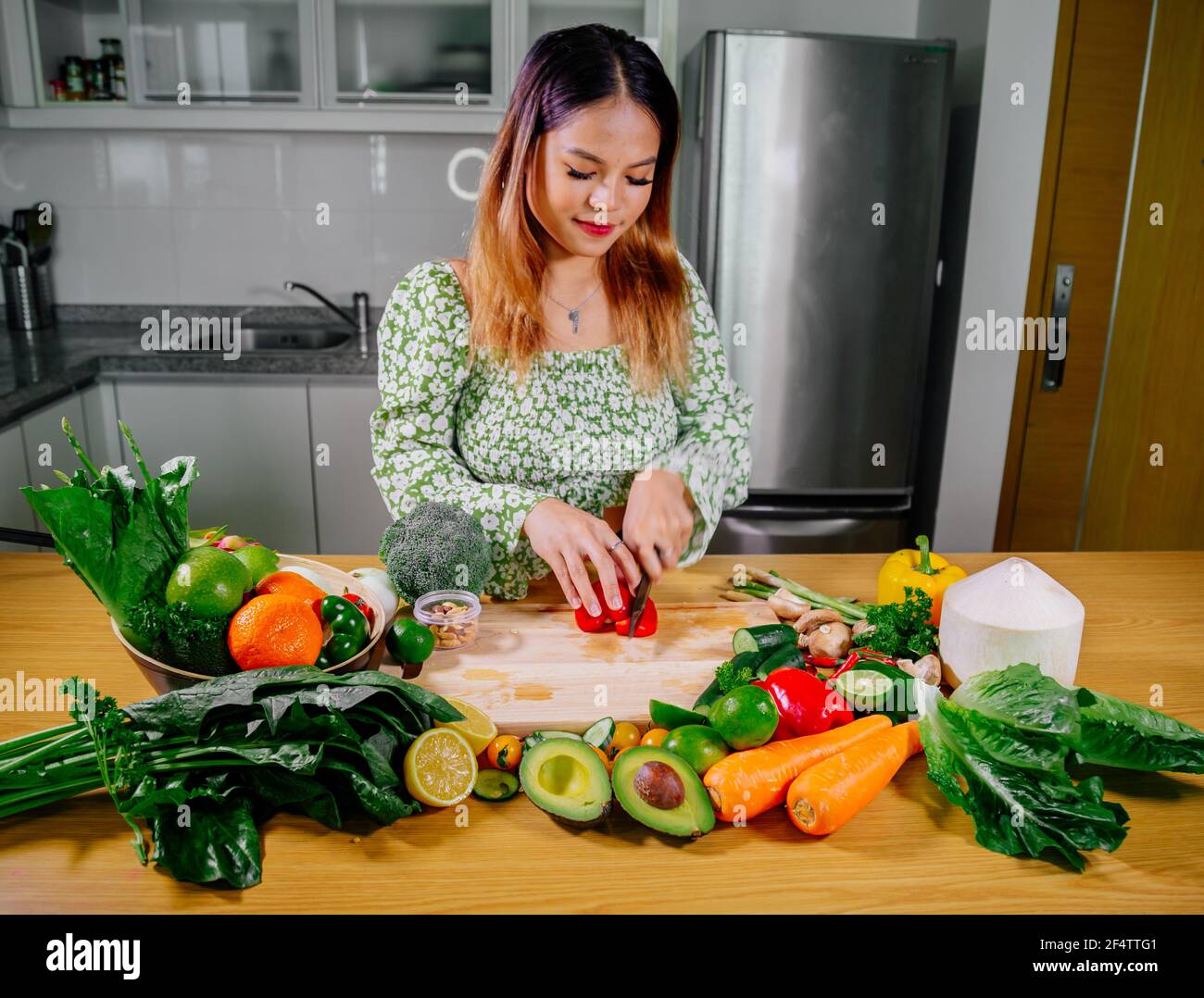 Asian girl cooking healthy vegetarian and vegan food, vegetables and ...