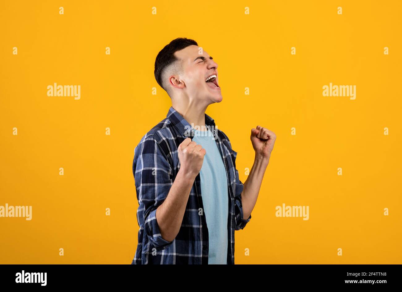 Overjoyed millennial guy making YES gesture with both hands, feeling ...