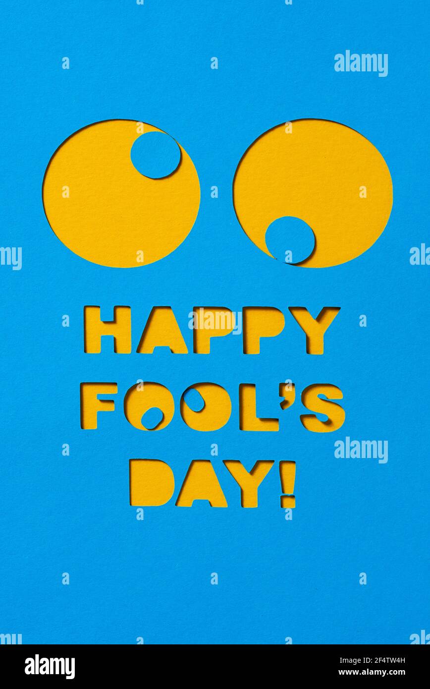 a pair of funny eyes and the text happy fools day cut out in a blue ...