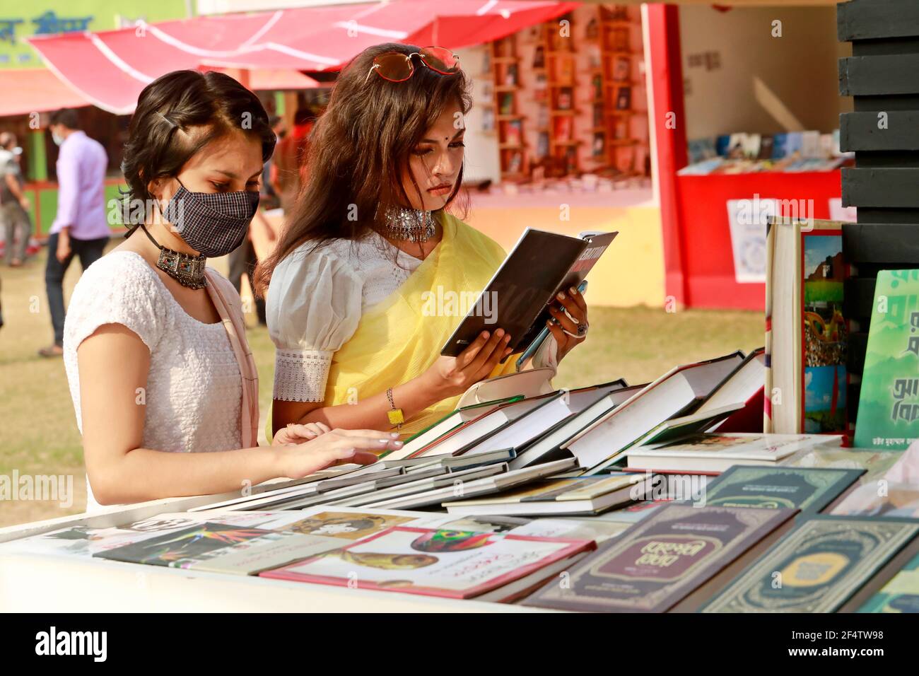 Dhaka, Bangladesh - March 23, 2021: Bangladeshi Visitors browse books ...