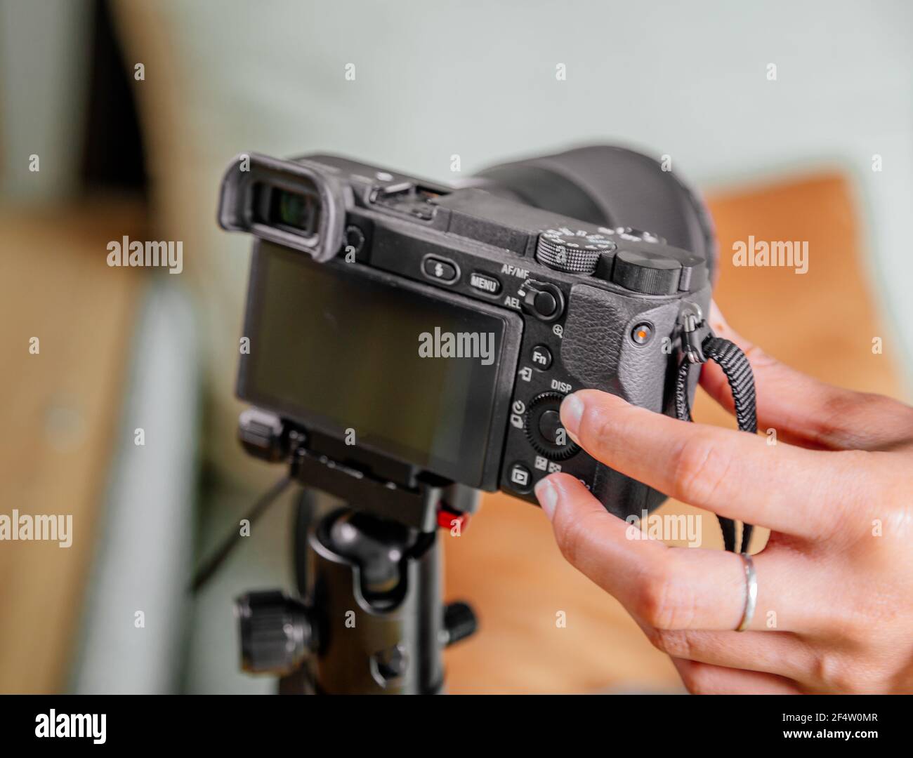 Asian female blogger setting up her digital camera before making a new ...