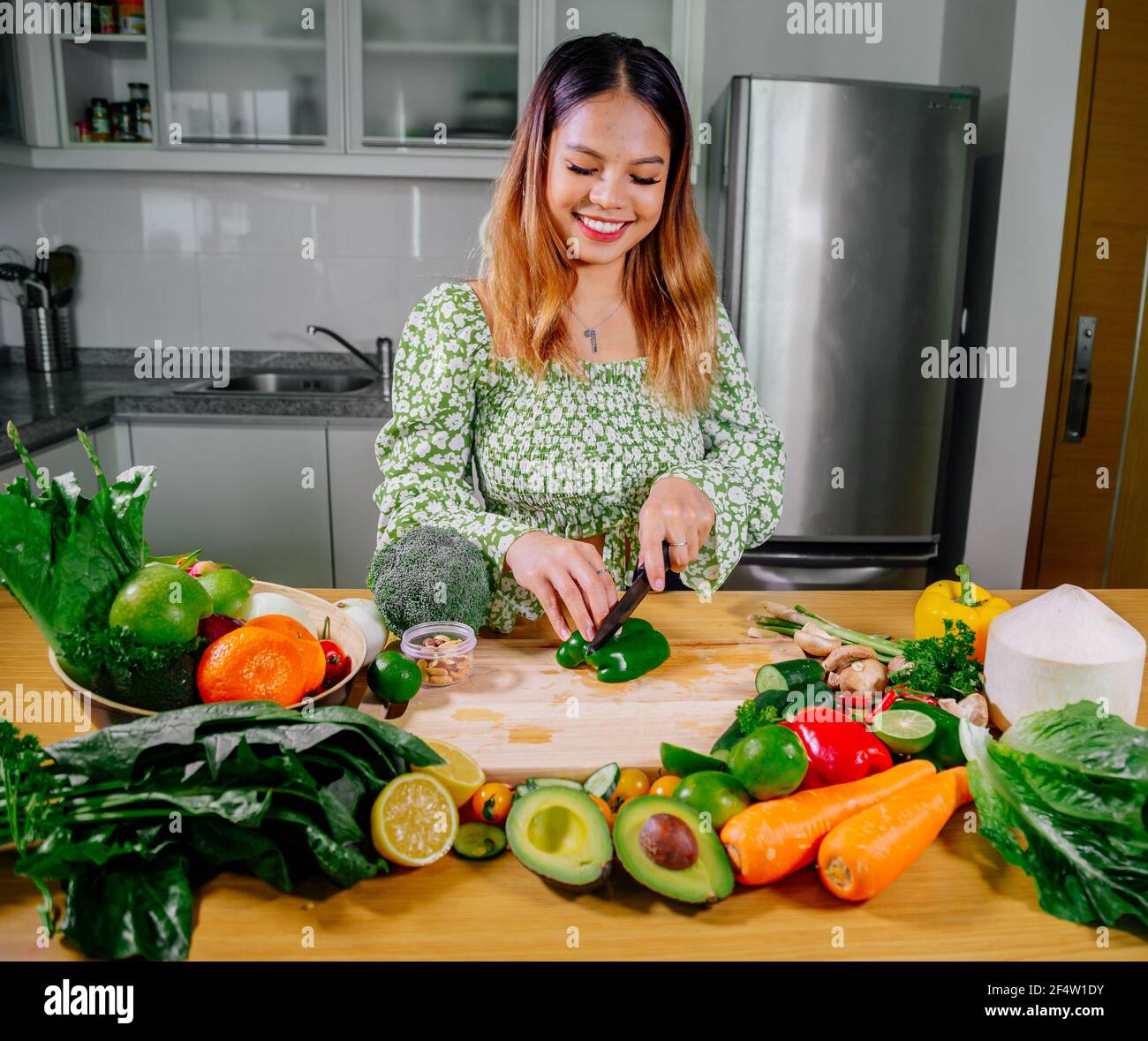 Asian girl cooking healthy vegetarian and vegan food, vegetables and ...