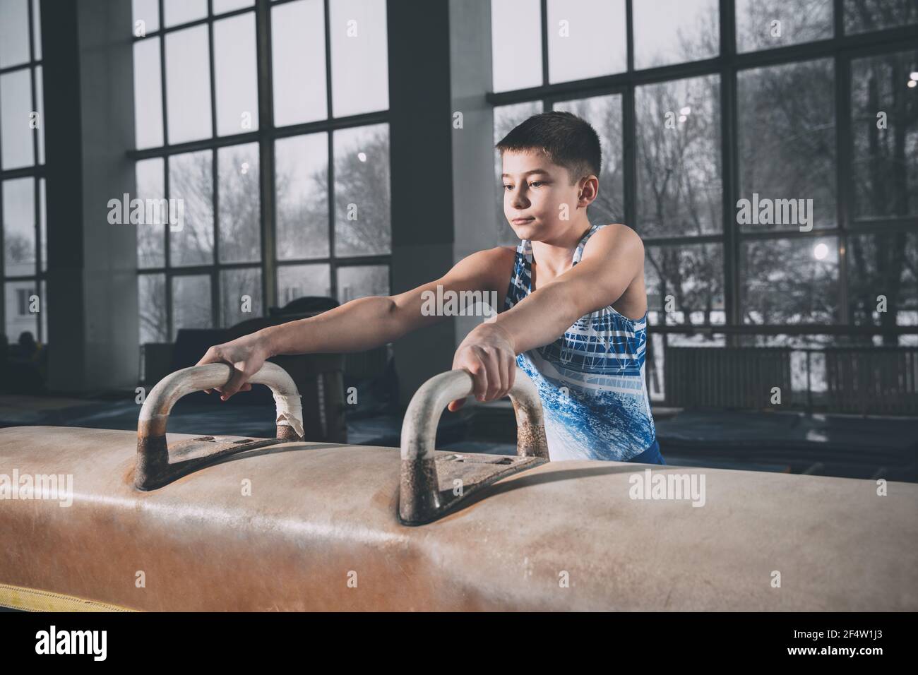 Little male gymnast training in gym, flexible and active. Caucasian fit ...