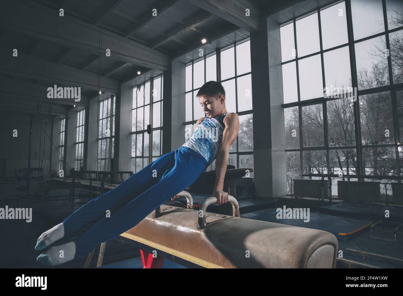 Little male gymnast training in gym, flexible and active. Caucasian fit ...
