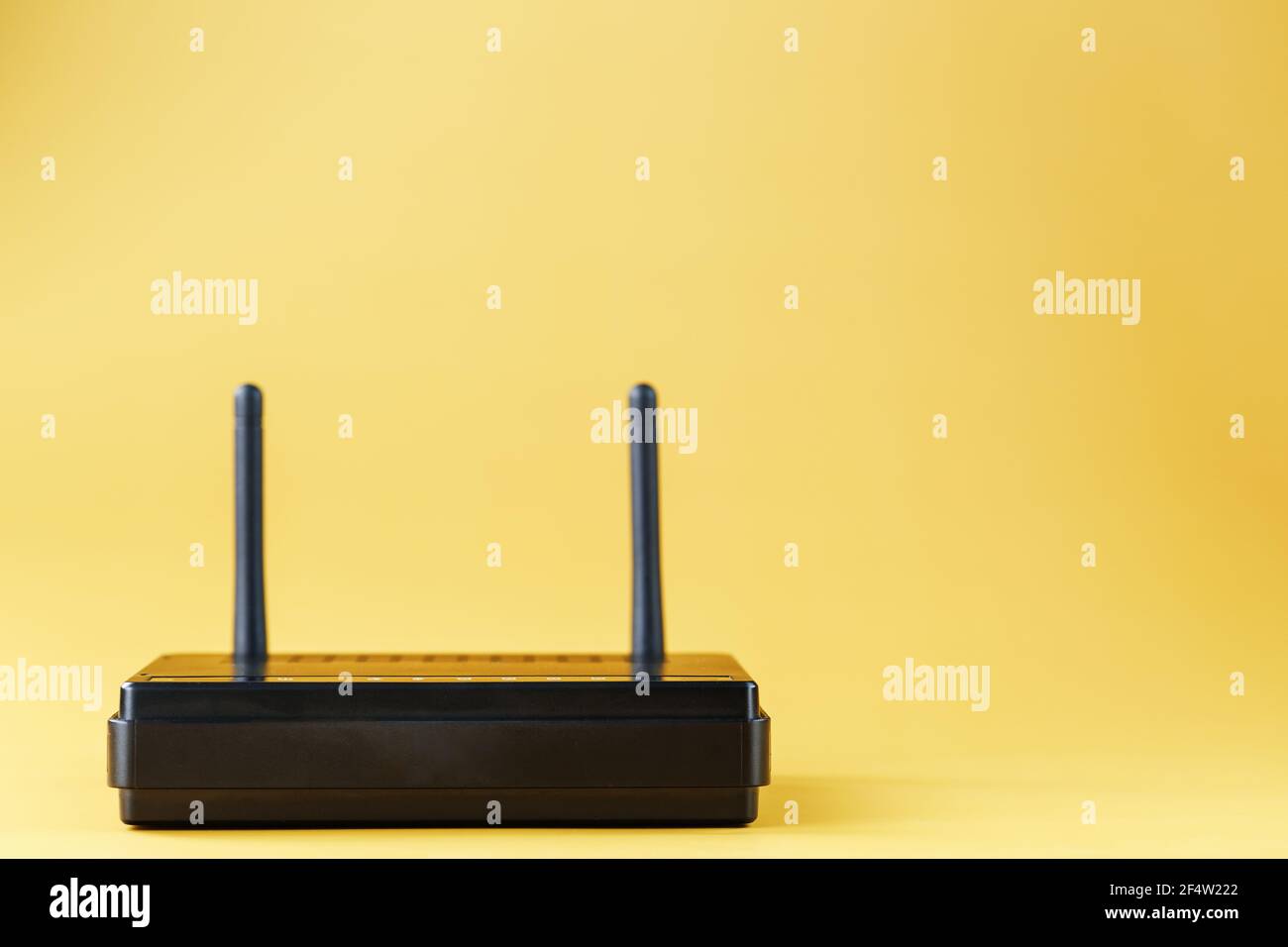 Wi-Fi router in black on a yellow background with free space. Internet ...