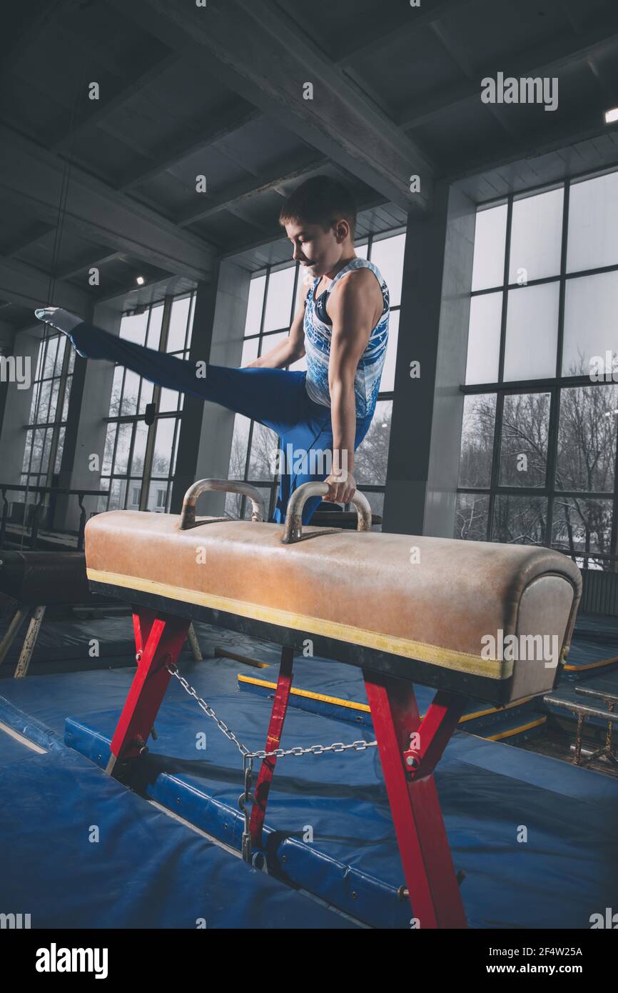 Little male gymnast training in gym, flexible and active. Caucasian fit ...