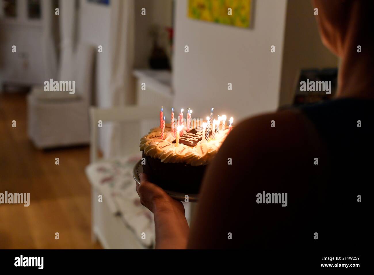 Woman holds birthday cake with flaming candles hi-res stock photography ...