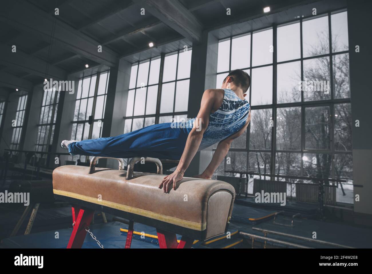 Little male gymnast training in gym, flexible and active. Caucasian fit ...