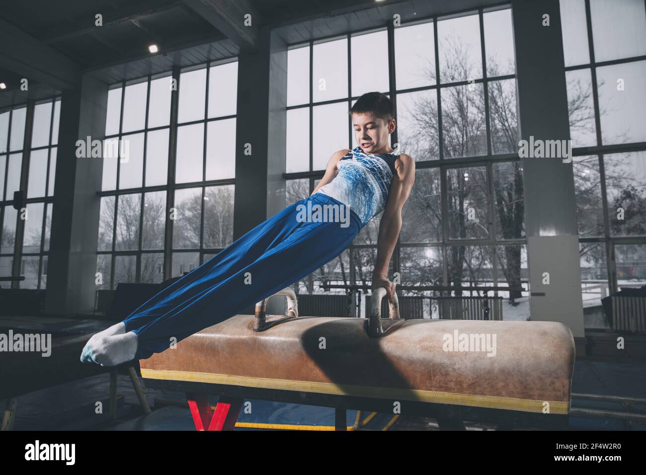 Little male gymnast training in gym, flexible and active. Caucasian fit ...